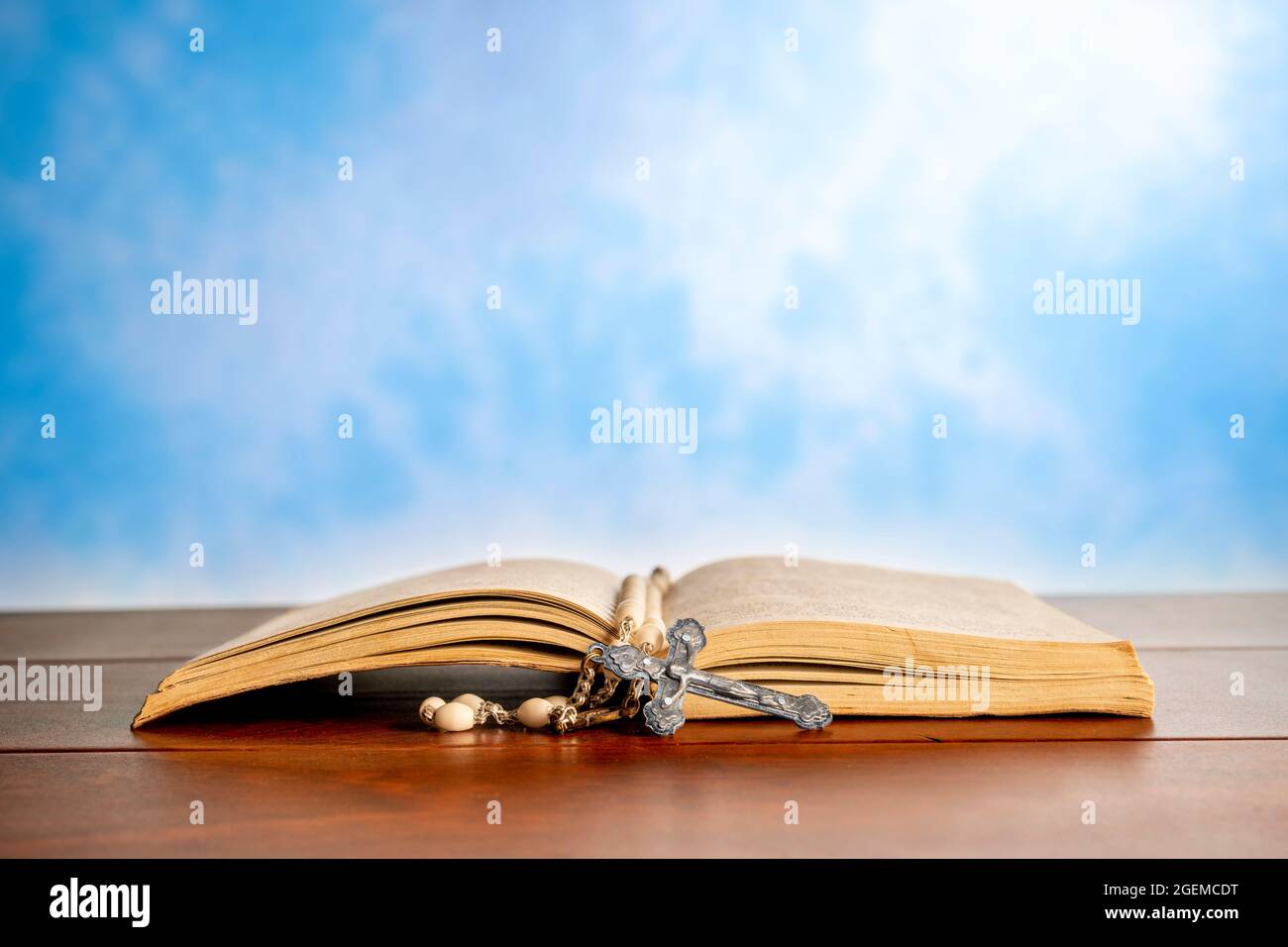 Dramatic image showing a bright light beam shining on an old bible with ...