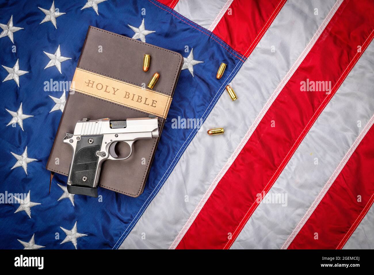 A Gun And Holy Bible Rests Atop An American Flag Representing God Guns And Freedom Of Religion