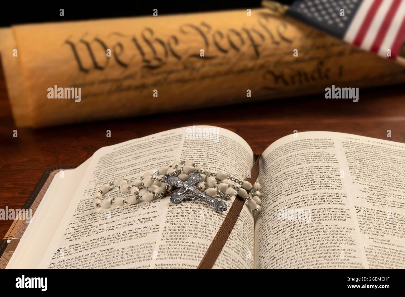 A holy bible and crucifix rest atop a podium with the United States ...