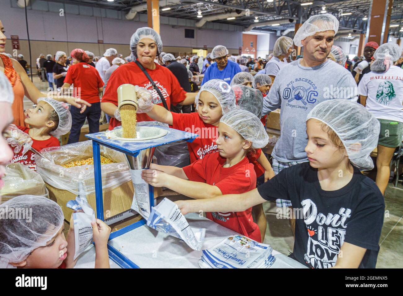 Volunteers volunteering working together packing meals hi-res stock ...