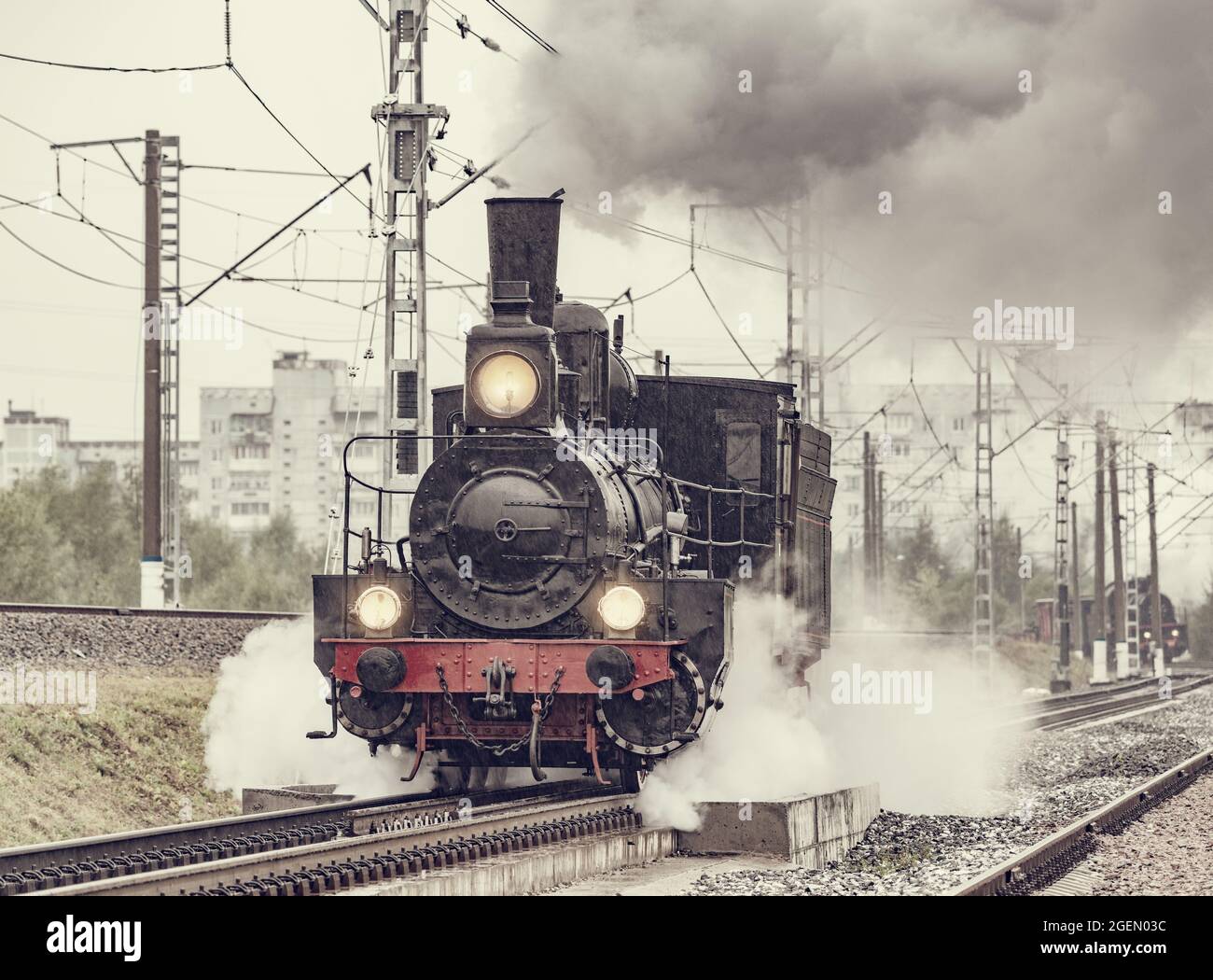Retro steam locomotive moves under the pouring rain Stock Photo - Alamy