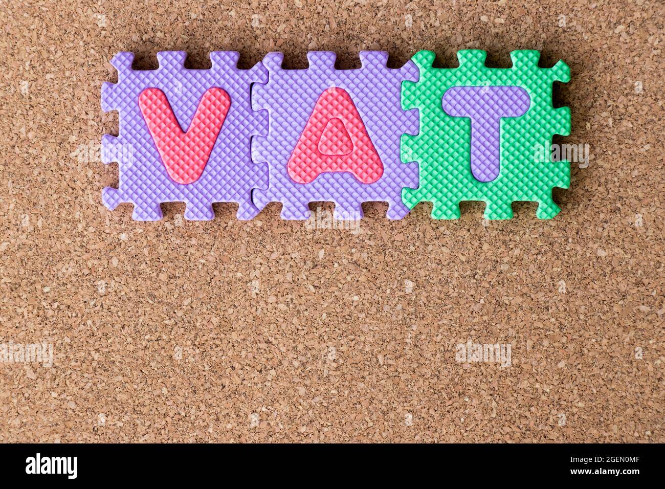 Colorful toy foam alphabet in word VAT on cork board background Stock ...