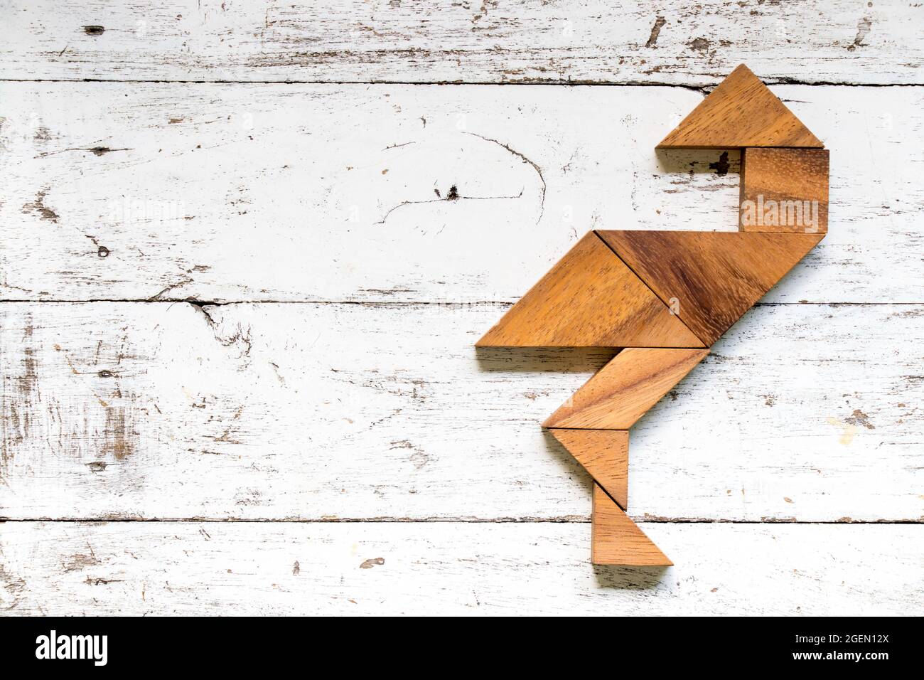Tangram puzzle in flamingo shape on old white wood background Stock ...