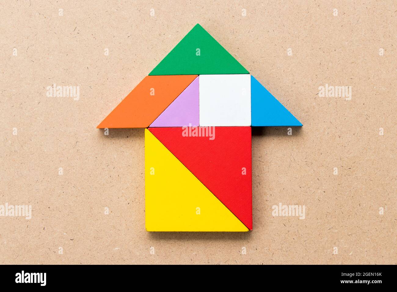 Color tangram puzzle in arrow or home shape on wood background Stock ...