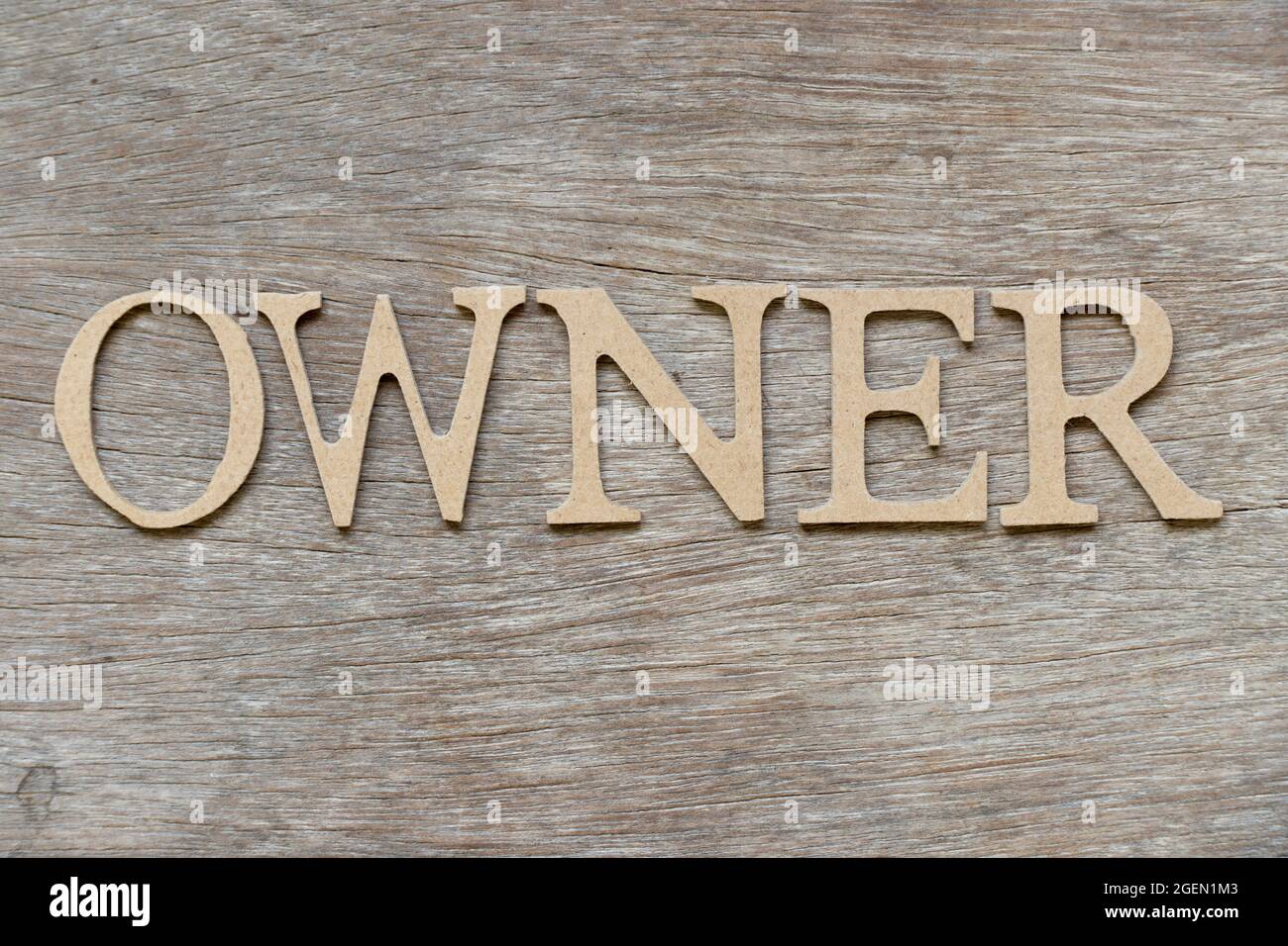 Alphabet letter in word owner on wood background Stock Photo - Alamy