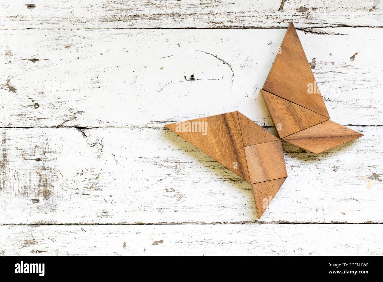 Tangram puzzle in butterfly shape on old white wood background Stock ...