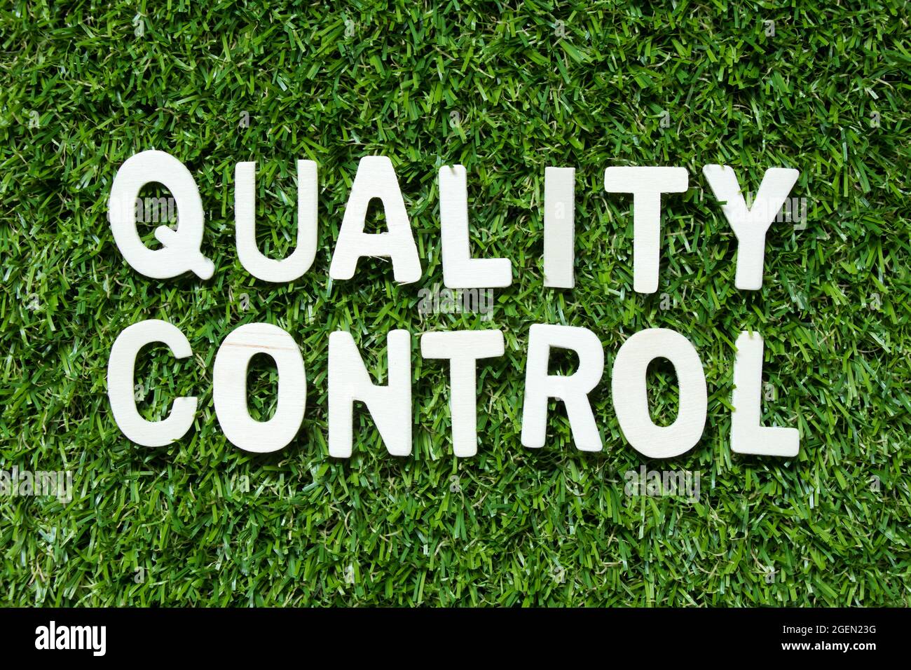 Alphabet letter in word quality control on artificial green grass ...