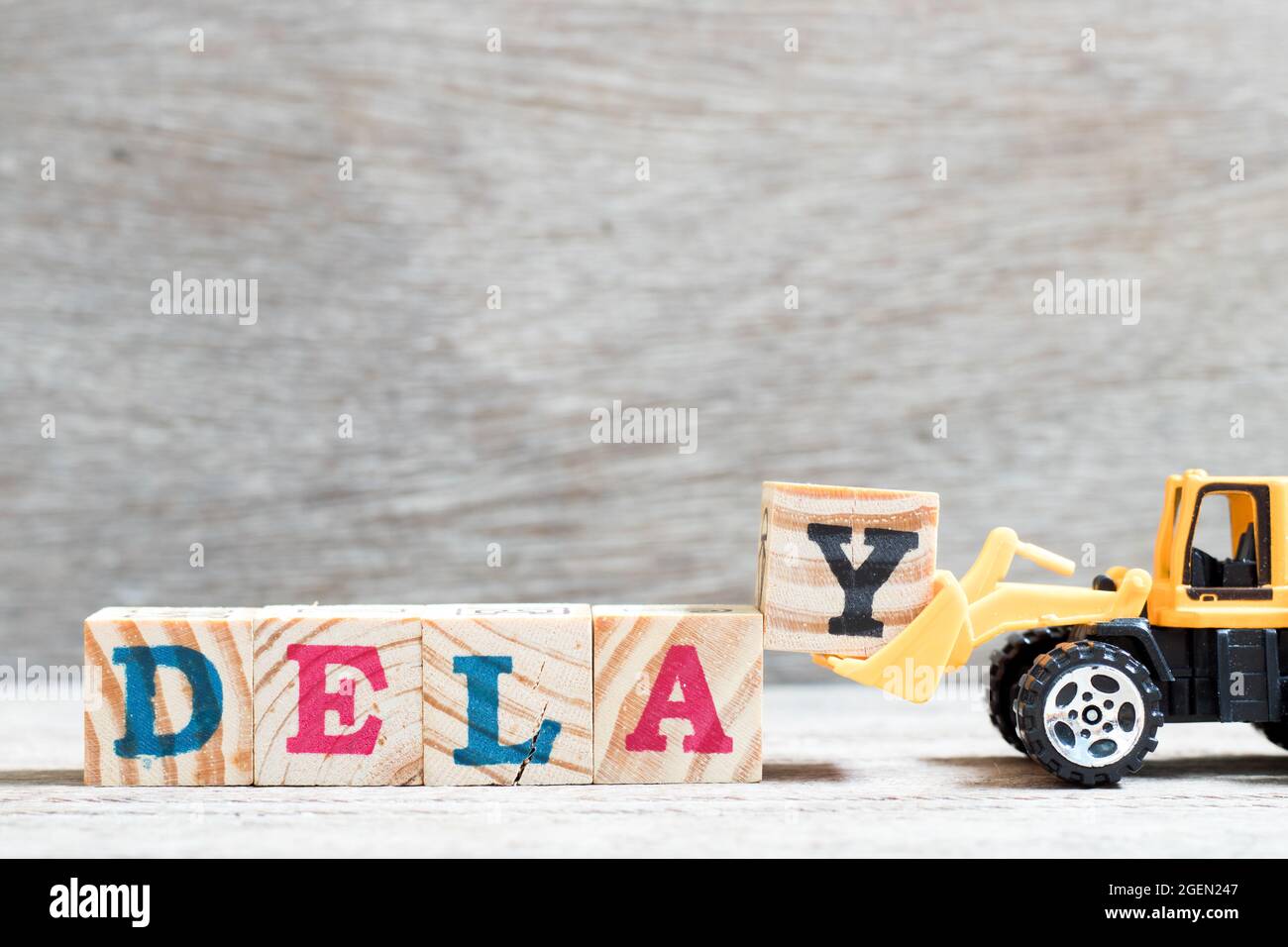 Toy bulldozer hold letter block y to complete word delay on wood ... Toy bulldozer hold letter block y to complete word delay on wood ...
