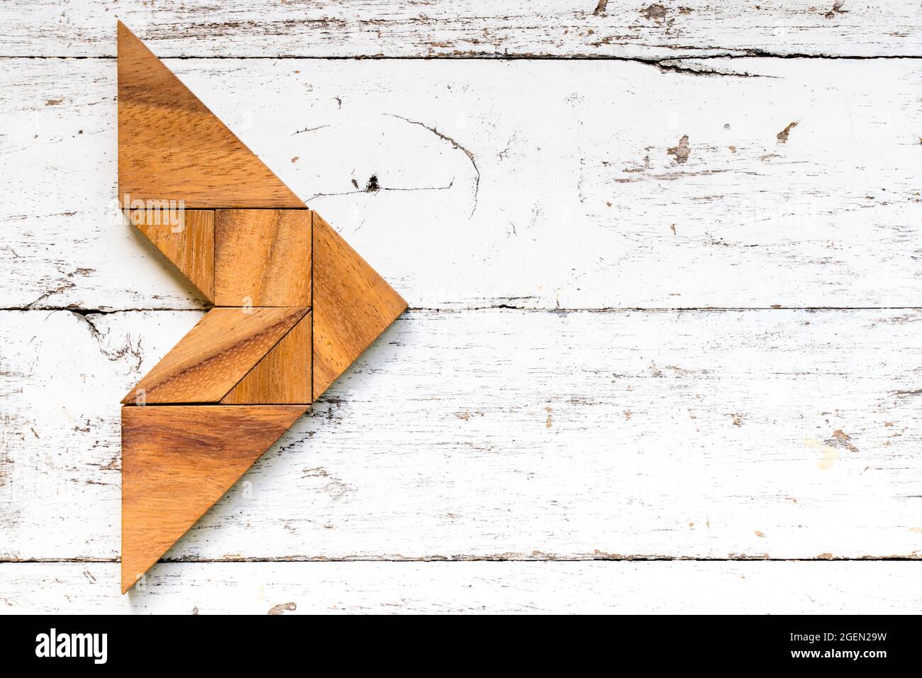 Tangram puzzle in arrow shape on old white wood background Stock Photo ...