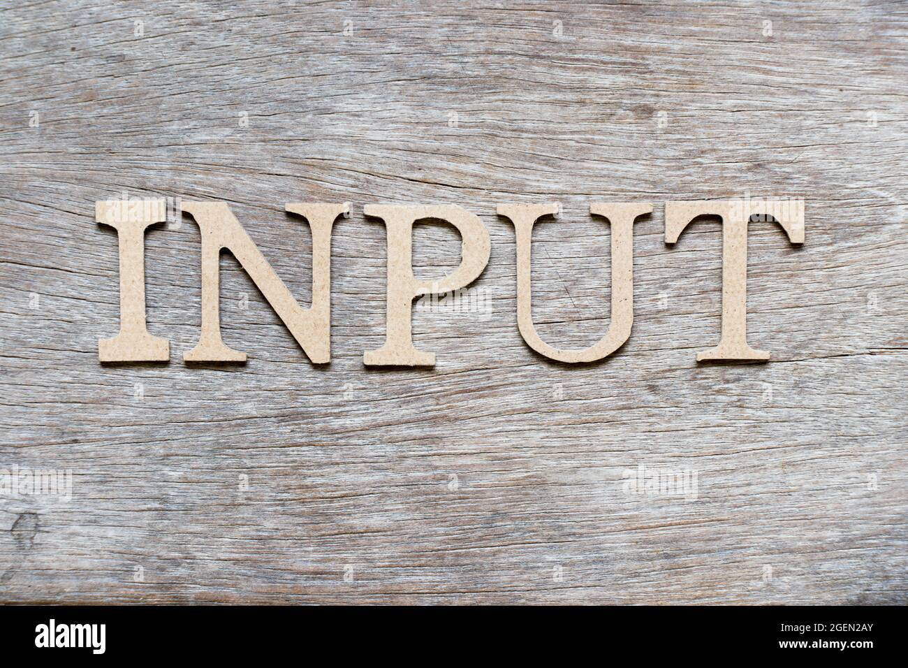 Alphabet letter in word input on wood background Stock Photo - Alamy
