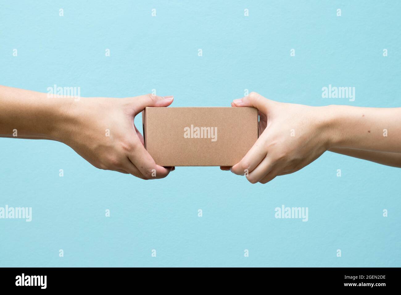 Woman hand received the borwn box delivery from freighter background ...