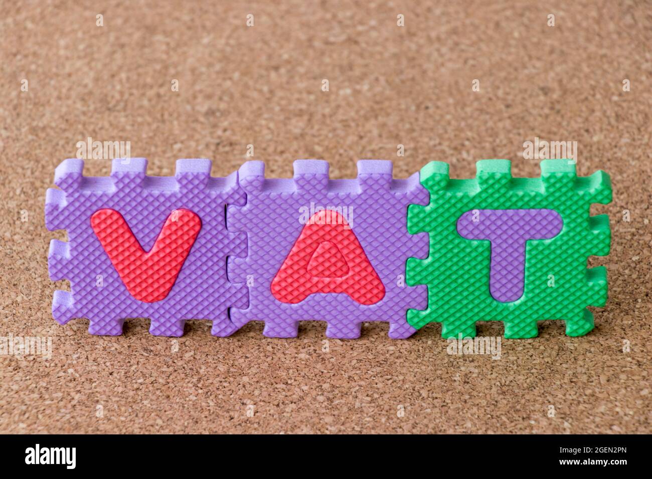 Colorful toy foam alphabet in word VAT on cork board background Stock ...
