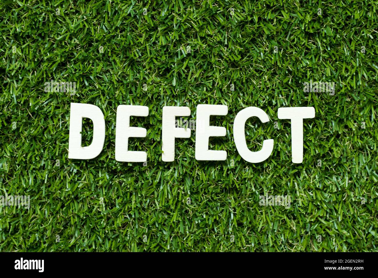 Alphabet letter in word defect on artificial green grass background ...