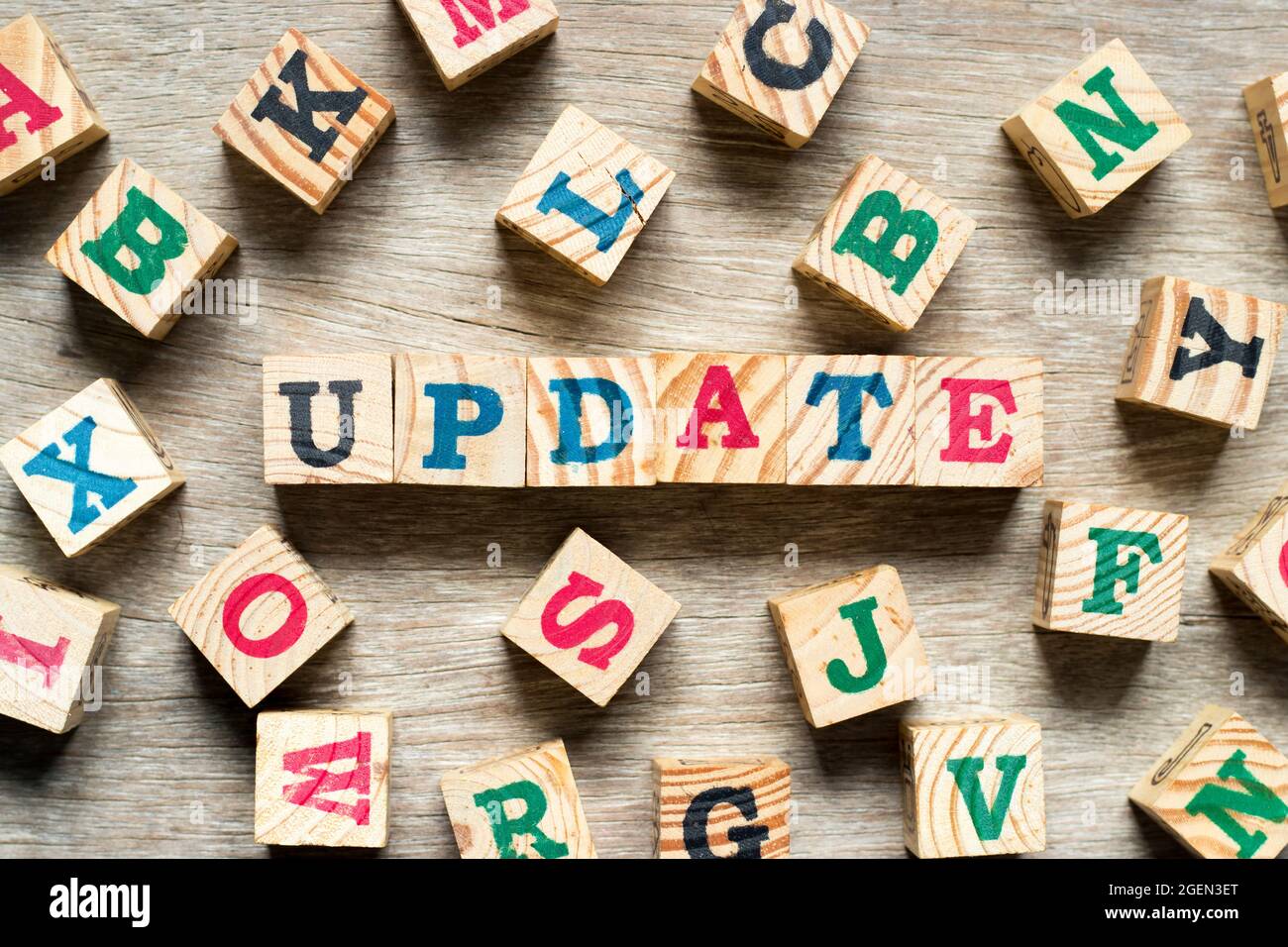 Letter block in word update with another alphabet on wood background ...