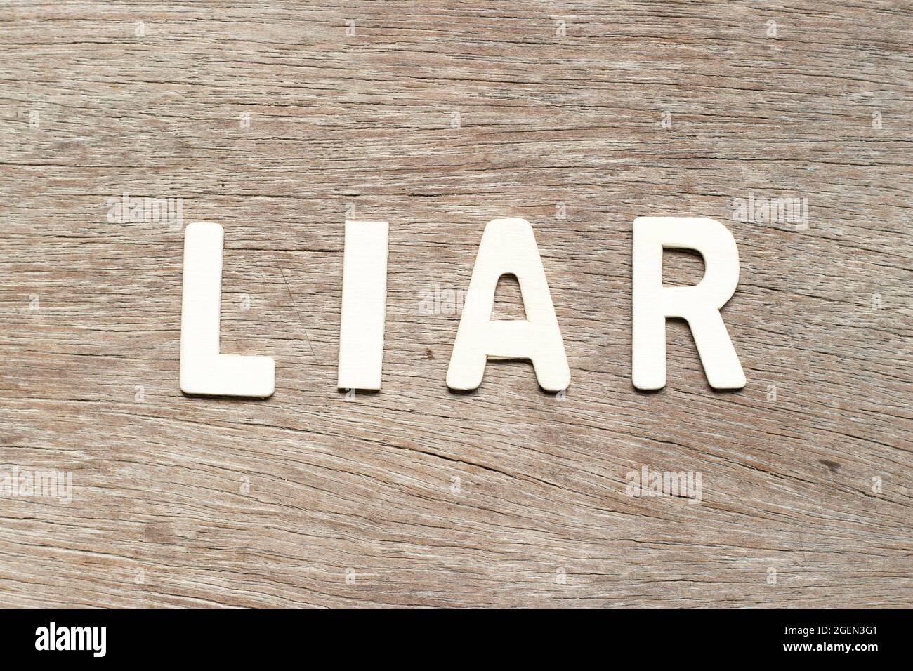 Alphabet letter in word liar on wood background Stock Photo - Alamy