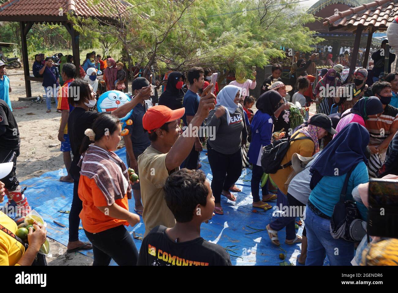 Crowded people celebrating sedekah bumi (javanese thanksgiving) in ...