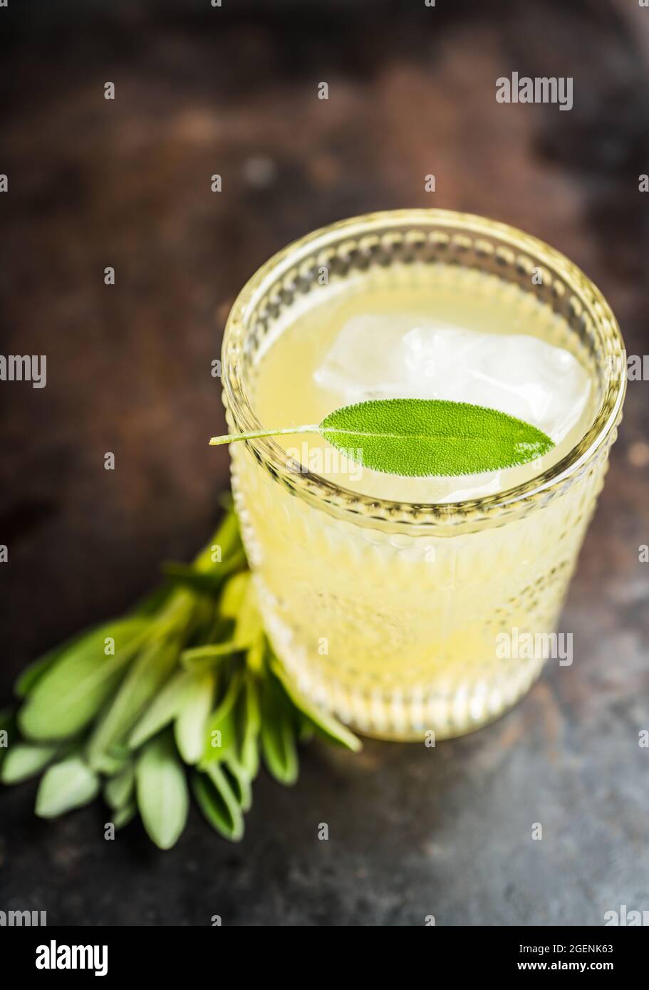 Gin based sweet old-fashioned cocktail mandarin juice and sage leaves ...
