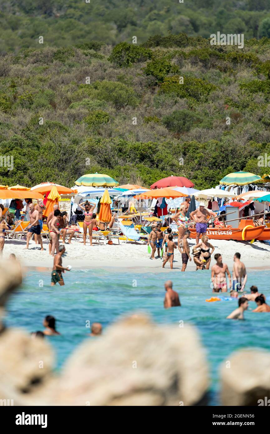 Stunning view of some tourists swimming and sunbathing on a white sand ...