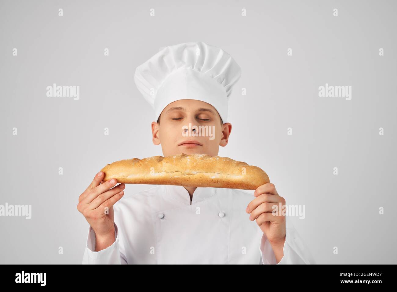 Baker in Chef's Clothes Holding a loaf of food cooking fresh Stock ...