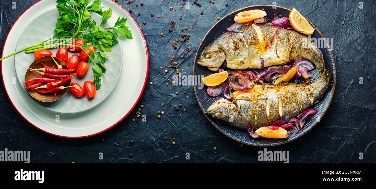 Tasty fish fried in onion and lemon. Baked rainbow trout, seafood Stock ...