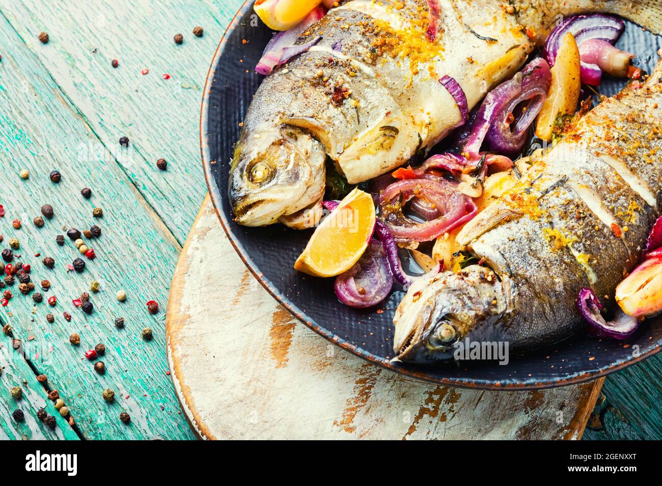 Tasty fish fried in onion and lemon. Baked rainbow trout, seafood Stock ...