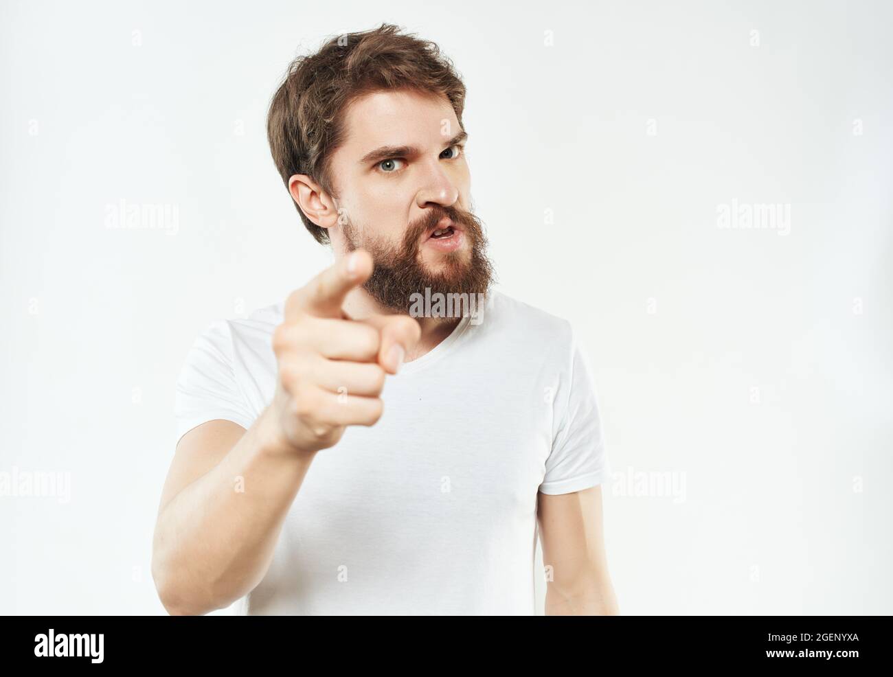Man in a white t-shirt serious look Studio Stock Photo - Alamy