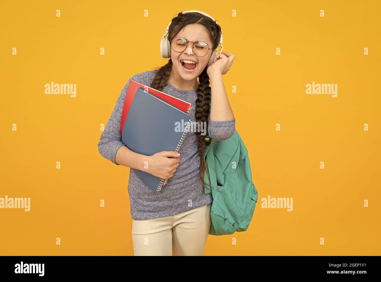 Modern student girl with backpack and school supplies yellow background ...