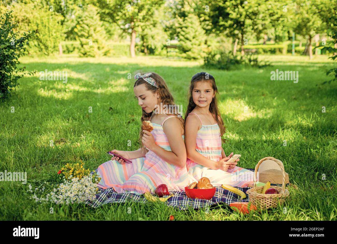 Little girls friends having picnic nature background, idyllic moment ...