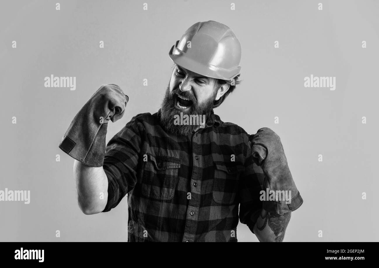 handsome bearded guy with beard and moustache wear gloves, building ...