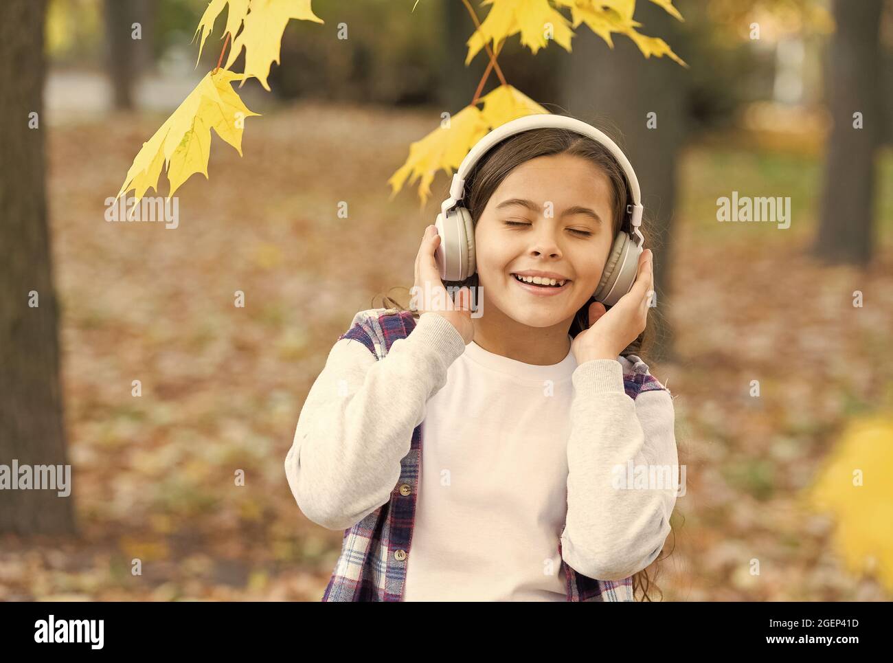 Best song about fall. Cute small child enjoy song playing in headphones ...
