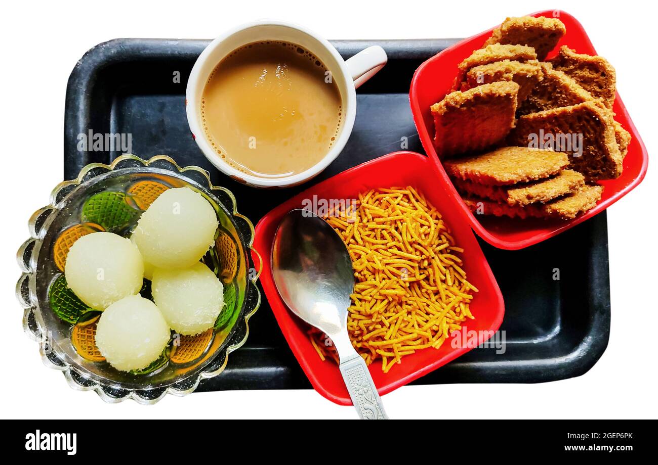 Tea and snacks with sweets for guests in india Stock Photo - Alamy