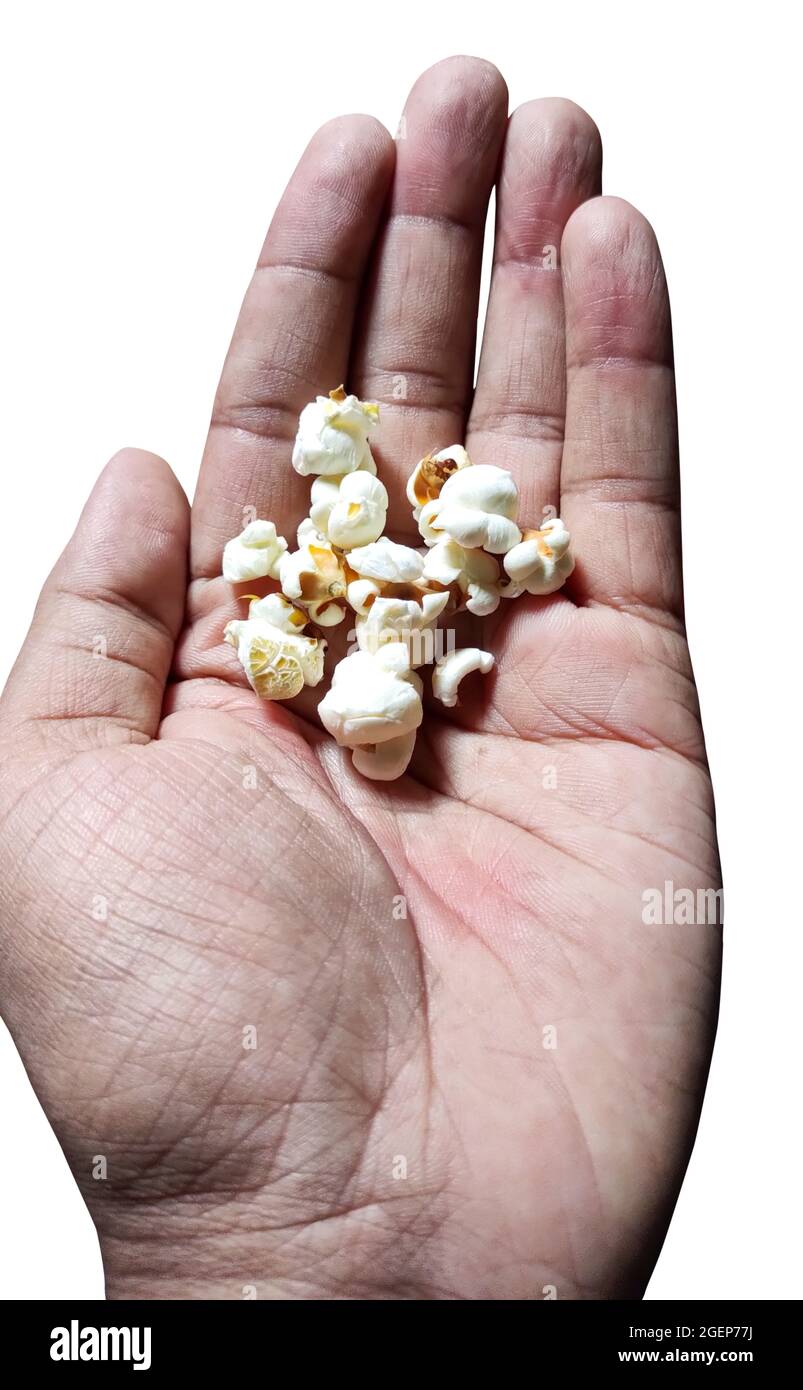 Top view of popcorn in hand isolated on white background Stock Photo ...