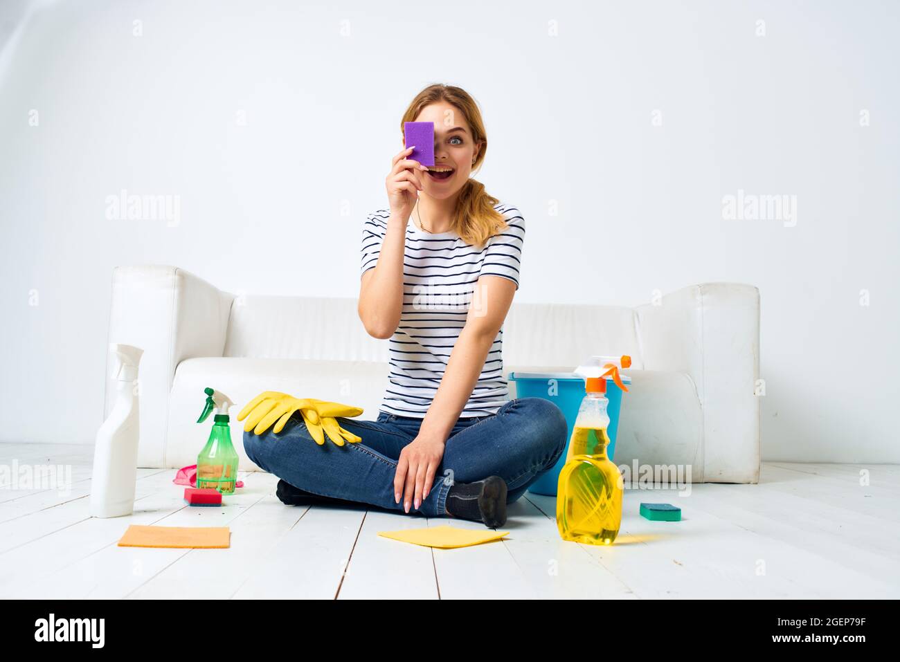 cleaning woman near the sofa detergent rags sponges provision of ...