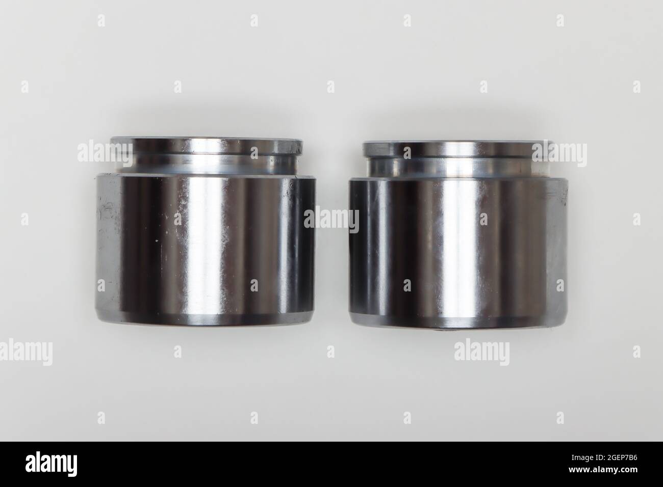 Two metal identical pistons, parts for car repair. A set of spare parts ...