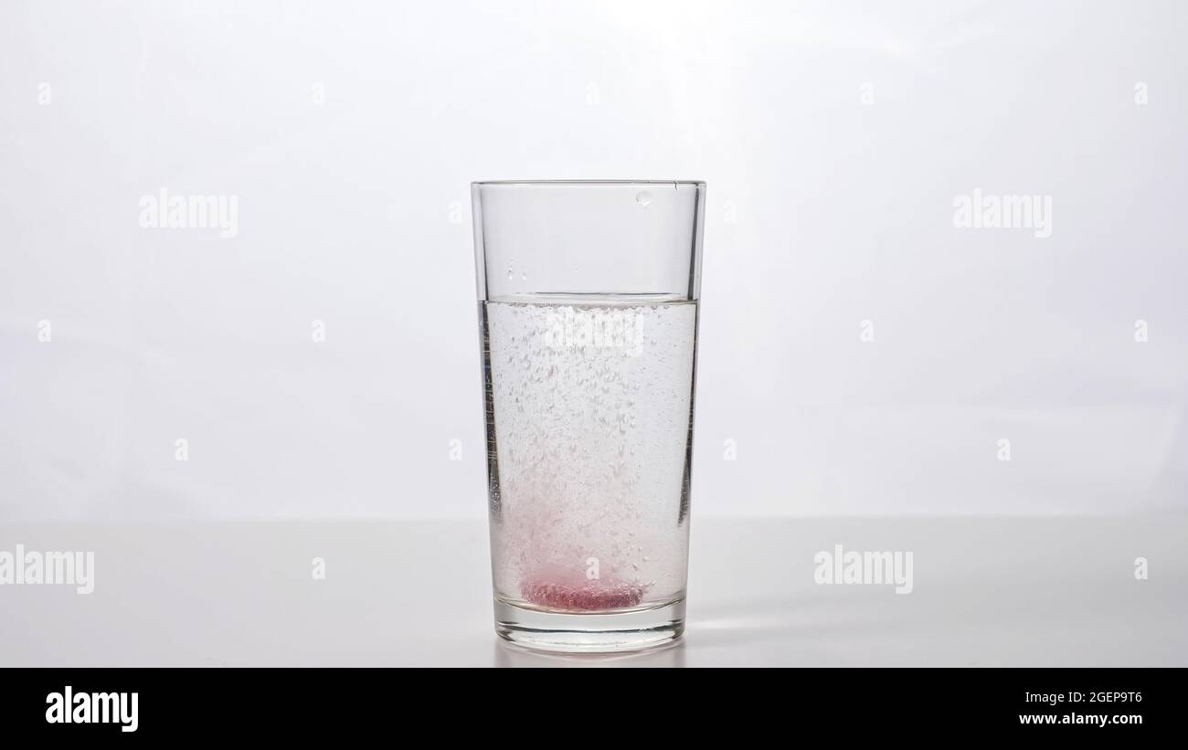 Hand drop dissolve tablet water hi-res stock photography and images - Alamy