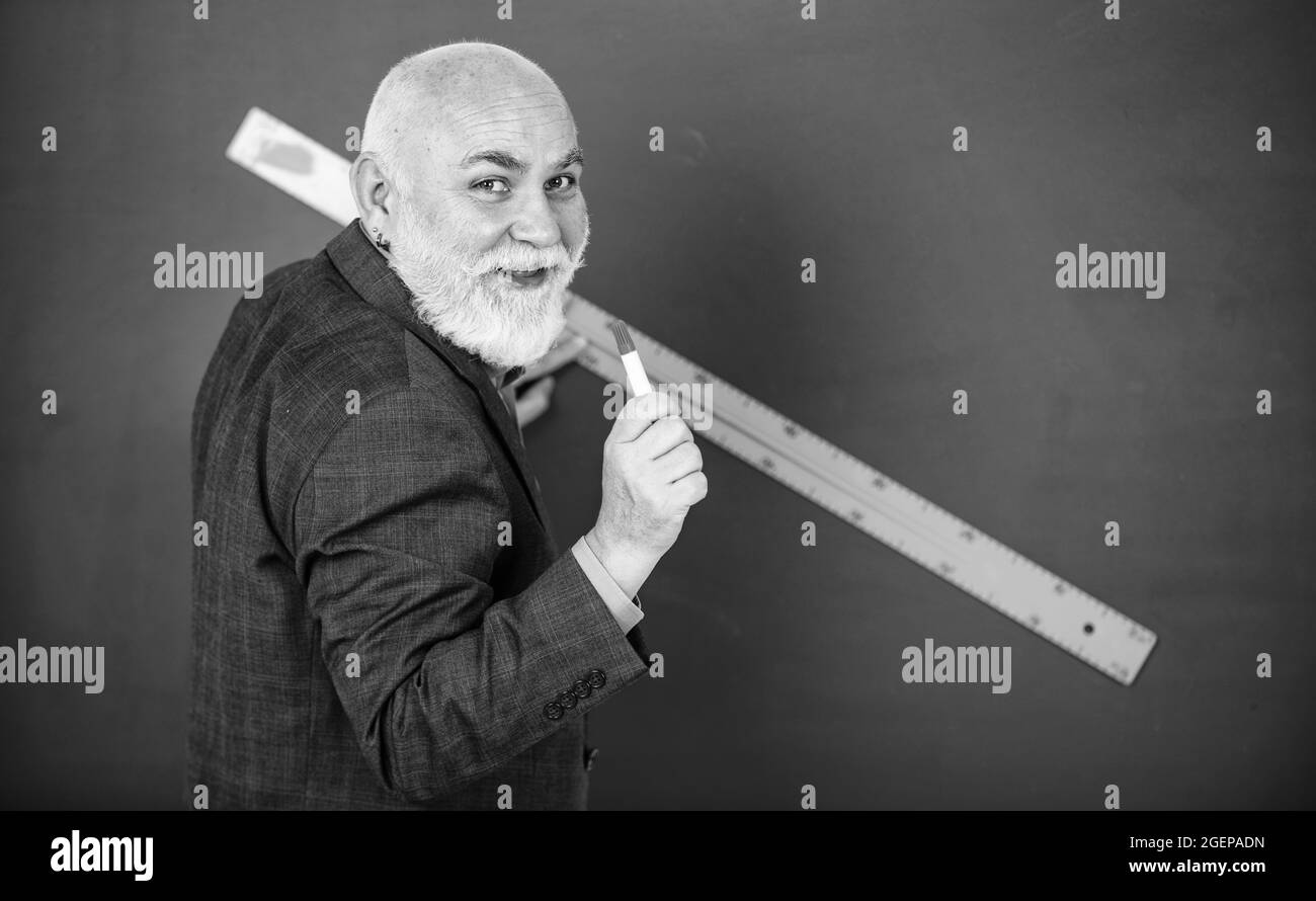 Education and knowledge. geometric shapes at high school. senior man ...