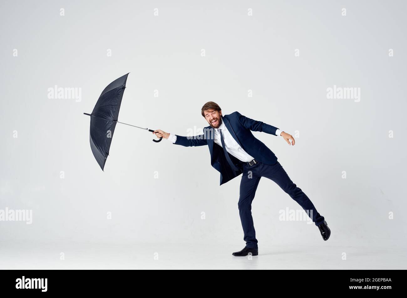 man wearing umbrella rain protection weather Stock Photo - Alamy