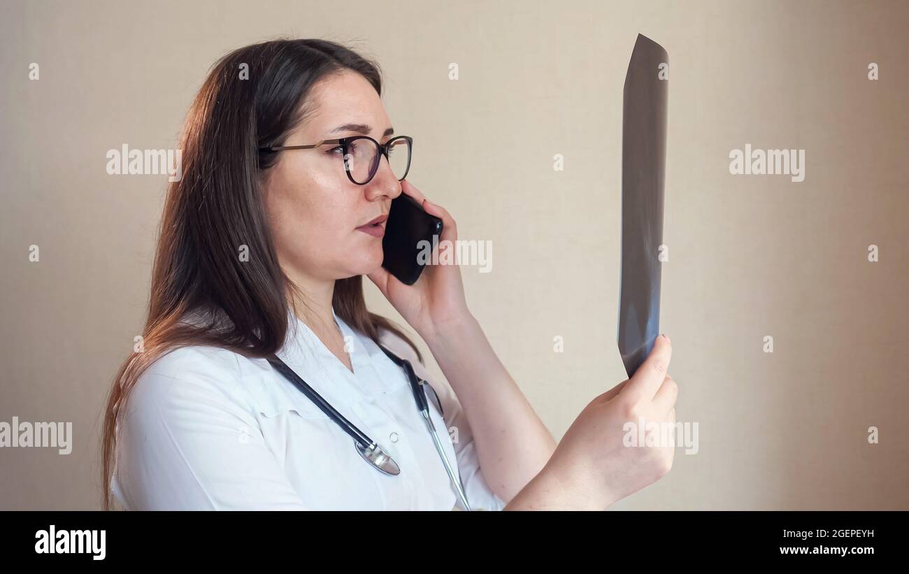 Doctor looking ray picture on hi-res stock photography and images - Alamy