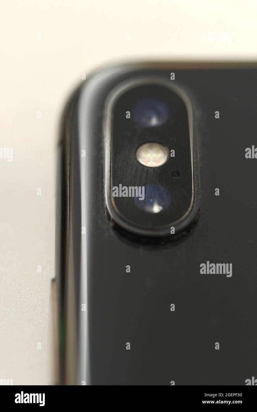 Closeup macro of camera of a mobile smart phone on white background ...