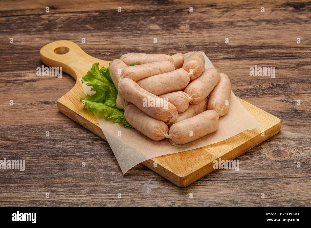 Raw natural chicken baby sausages for roast Stock Photo - Alamy