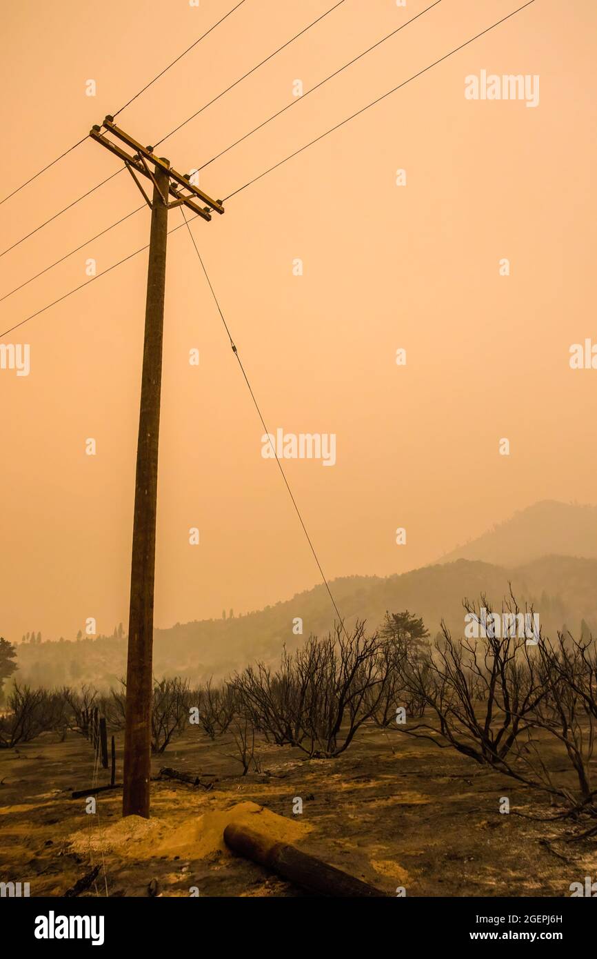Heavy smoke fills the air over a burned area from the Dixie fire. A ...