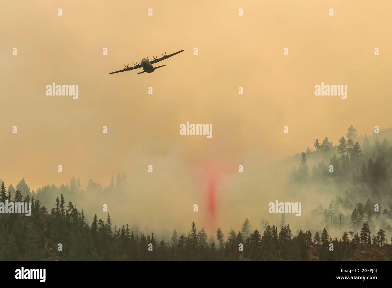 A national guard plane drops fire retardant on the Dixie fire. A spot ...