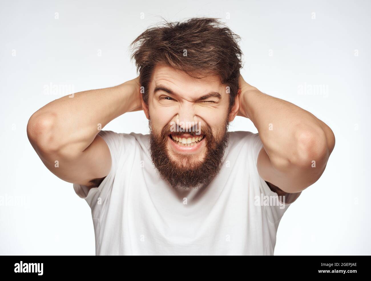 Man in a white t-shirt hand gestures anger Studio Stock Photo - Alamy