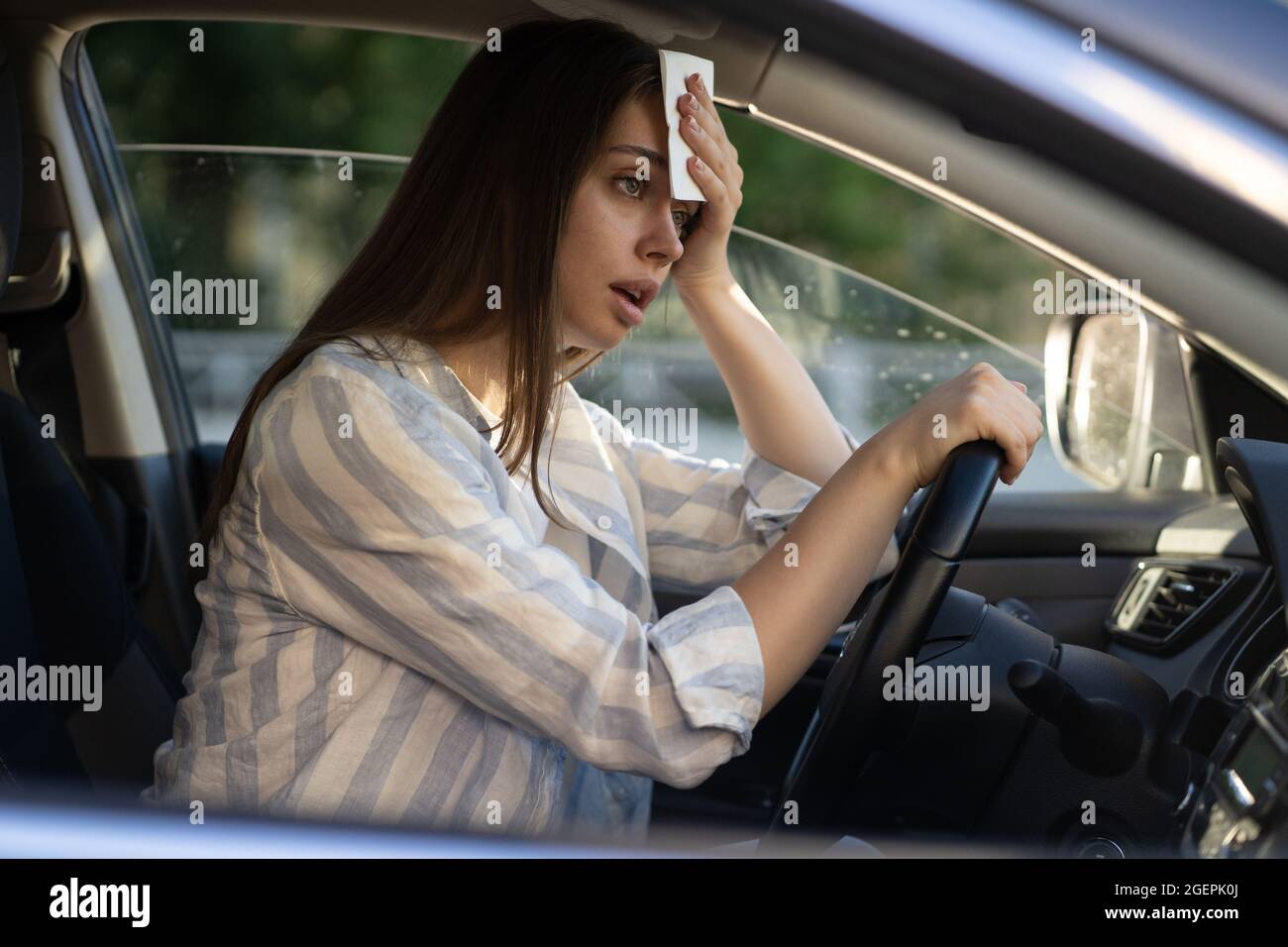 Woman driver being hot during heat wave in car, suffering from hot ...
