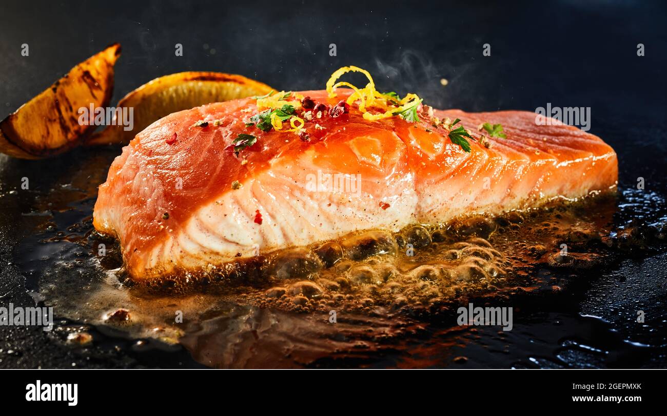 Gourmet cutlet of fresh salmon seasoned with herbs, spices, and lemon ...