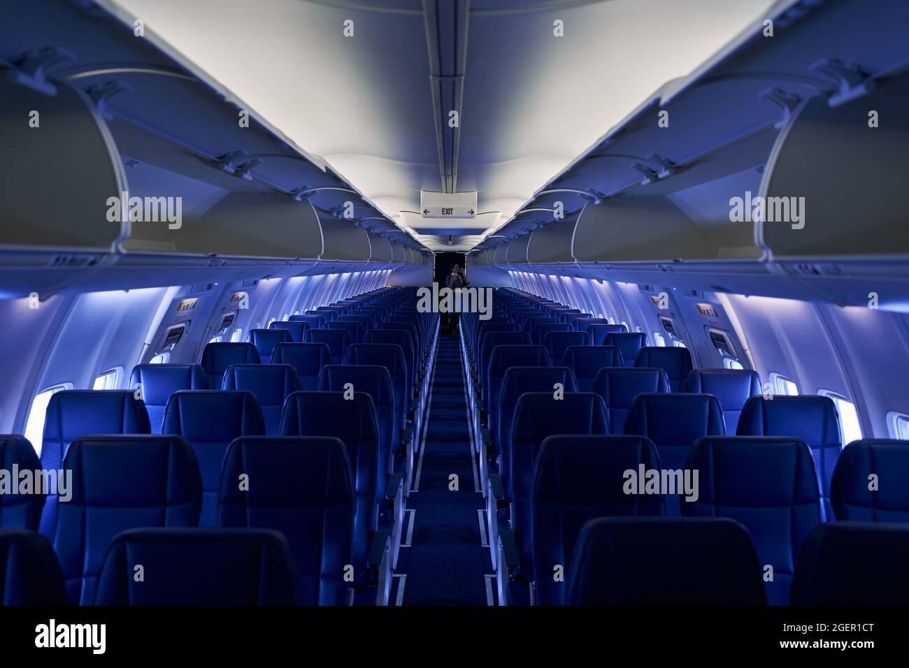 Stewardess looking at herself in the compact mirror aboard the aircraft ...