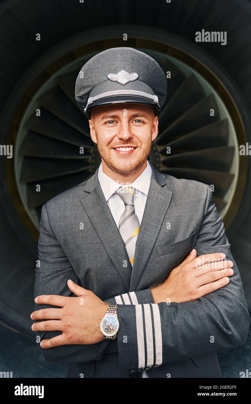 Happy young aviator standing by a turbofan engine Stock Photo - Alamy