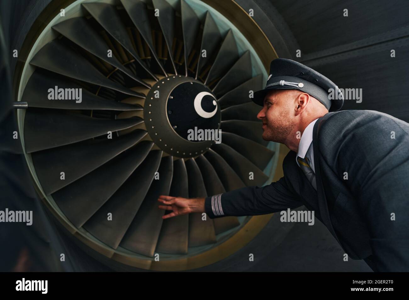 Professional pilot checking the turbofan engine before the take-off ...