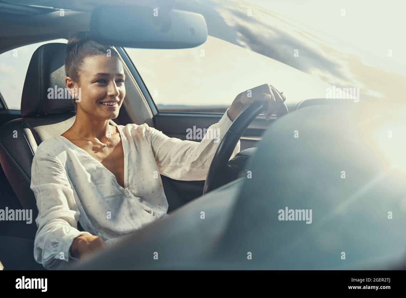 Female having a car drive on sunny day Stock Photo - Alamy