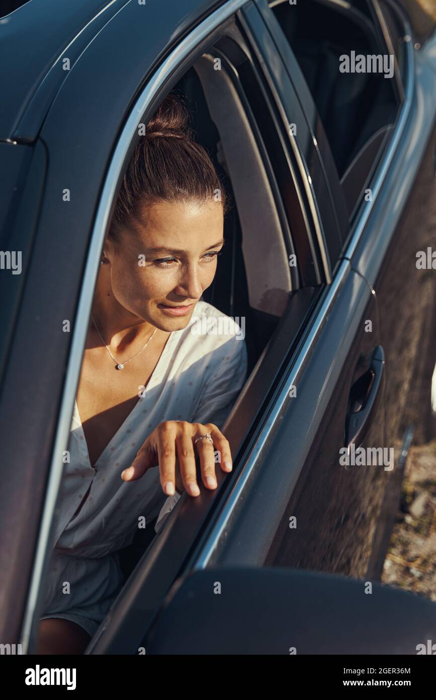 Female looking through the open car window Stock Photo - Alamy